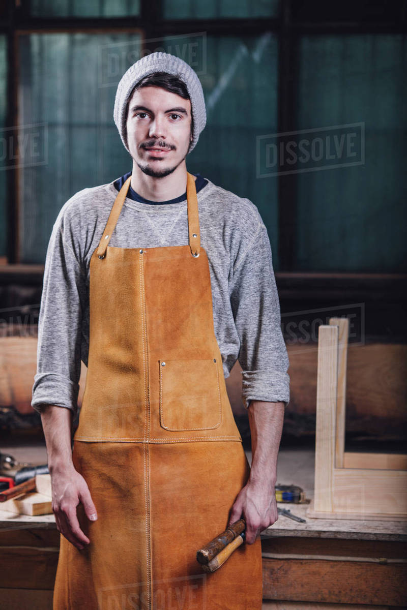 Portrait of carpenter holding hand tools at workshop - Royalty-free ...