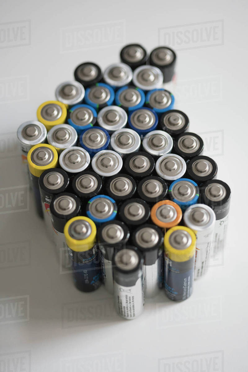 High angle view of batteries on white table - Royalty-free Stock Photo ...