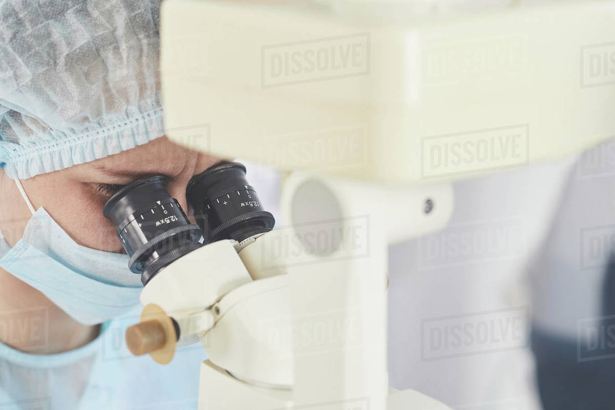 Surgeon using medical equipment during eye surgery - Royalty-free Stock ...