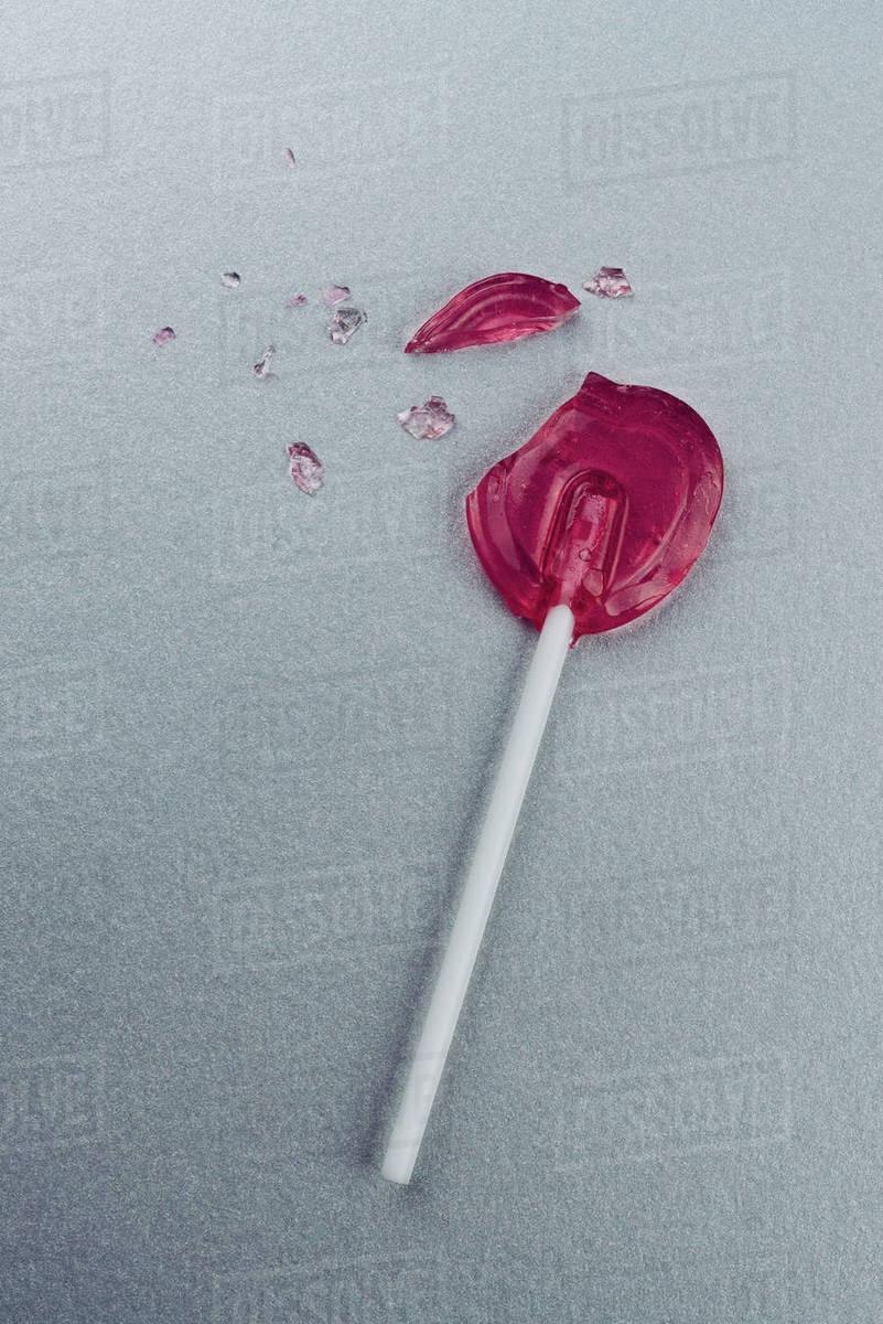 Broken heart-shape lollipop - Stock Photo - Dissolve