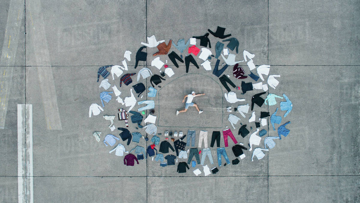 Knolling man surrounded by clothing wardrobe - Stock Photo - Dissolve