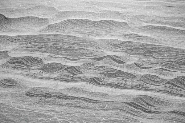 Rippled lines forming pattern on icy snow landscape - Stock Photo ...