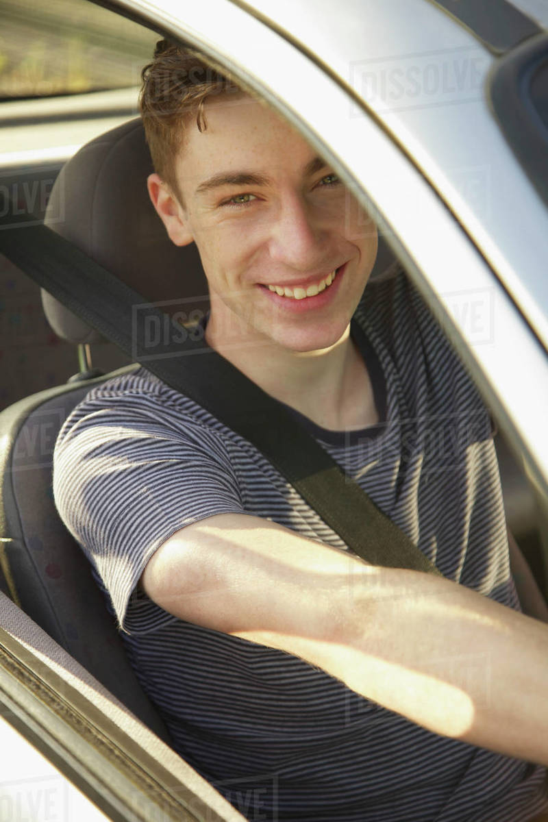 Smiling Teenage Boy Driving Car - Royalty-free Stock Photo | Dissolve